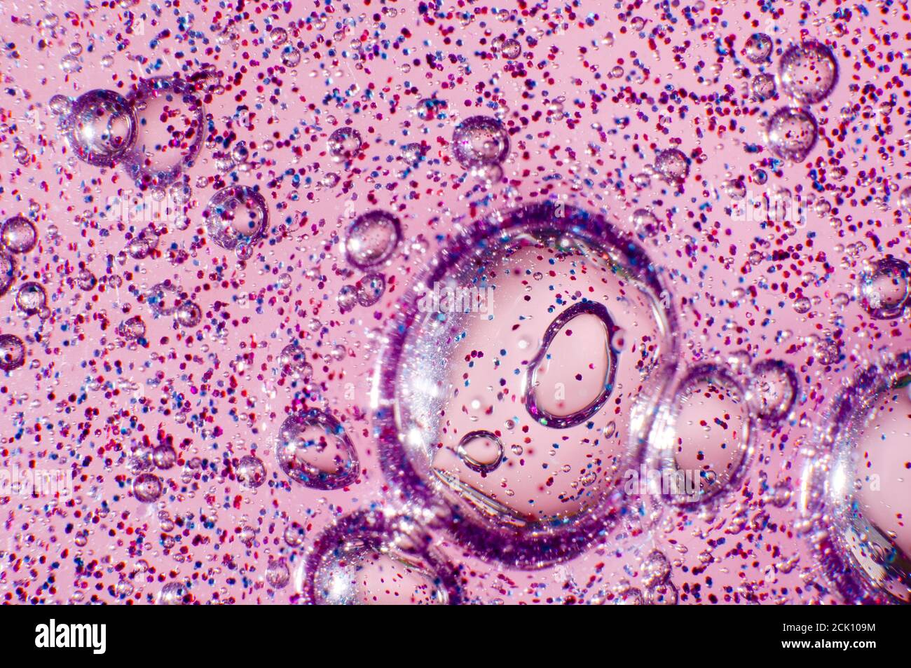 Macro of transparent glowing slime with glittering particles and ...