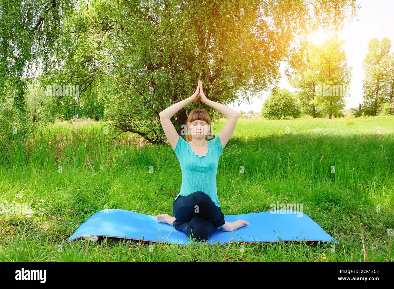 Beautiful pretty girl practicing yoga outdoor, relax place Stock Photo ...