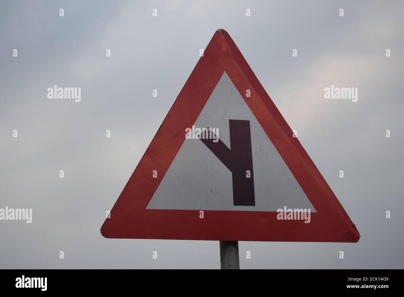 Closeup shot of a triangle street sign for road branching off Stock ...