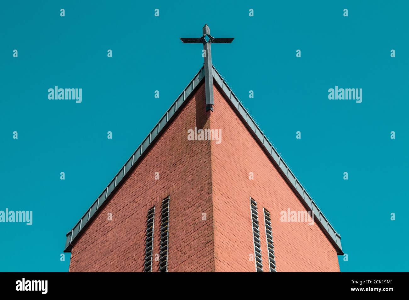 Low angle shot of a Catholic church tower with the Cross on the tops of ...