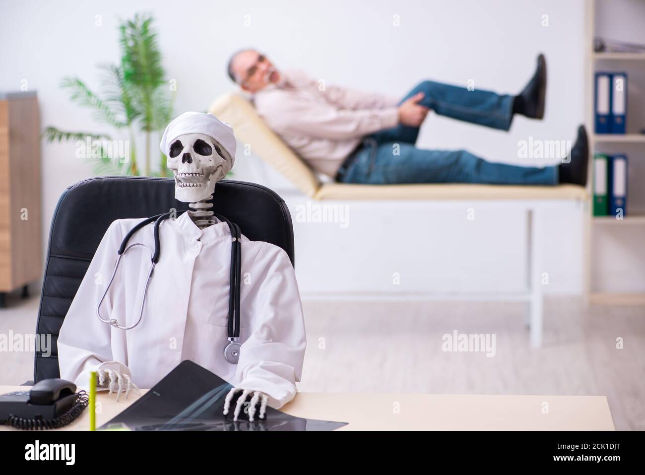 Skeleton doctor in funny medical concept Stock Photo - Alamy
