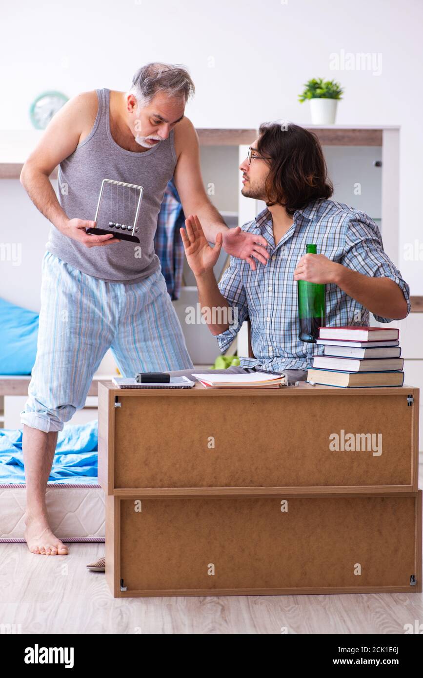 Young son student and dad alcoholic at home Stock Photo - Alamy