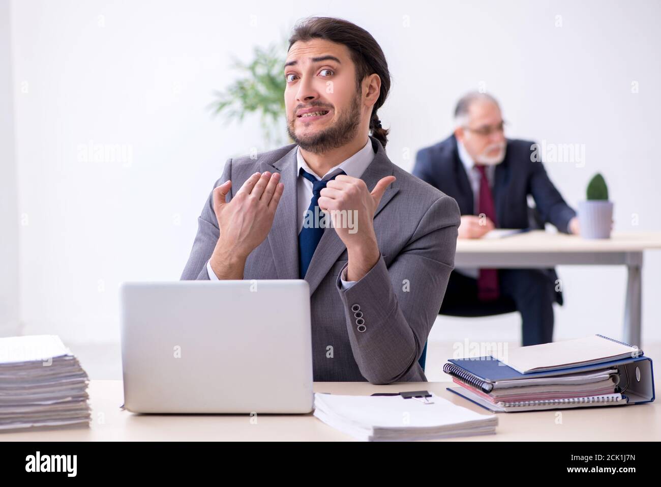 Old boss and his assistant working in the office Stock Photo - Alamy