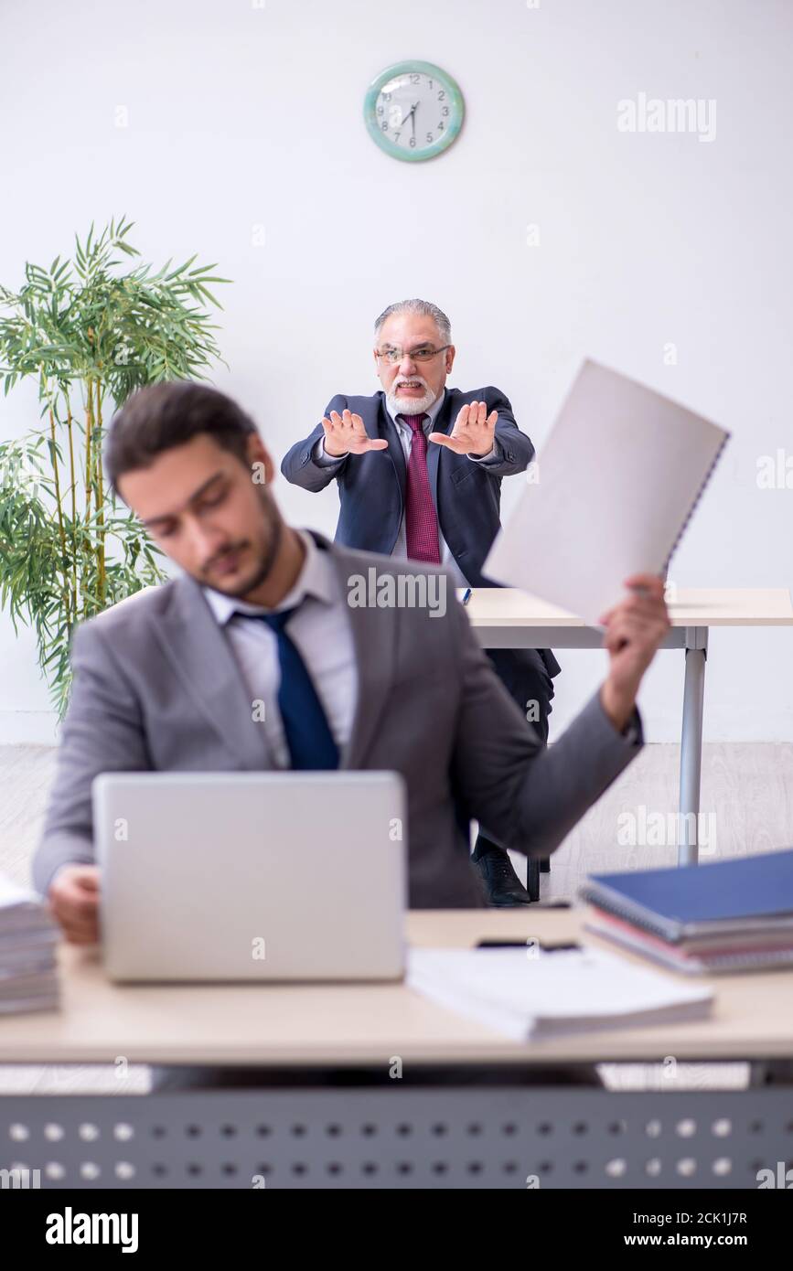 Old boss and his assistant working in the office Stock Photo - Alamy