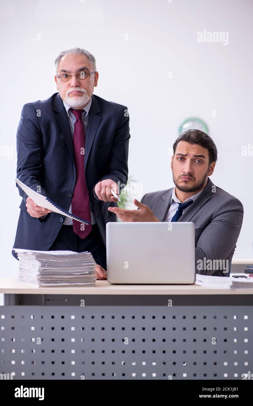 Old boss and his assistant working in the office Stock Photo - Alamy