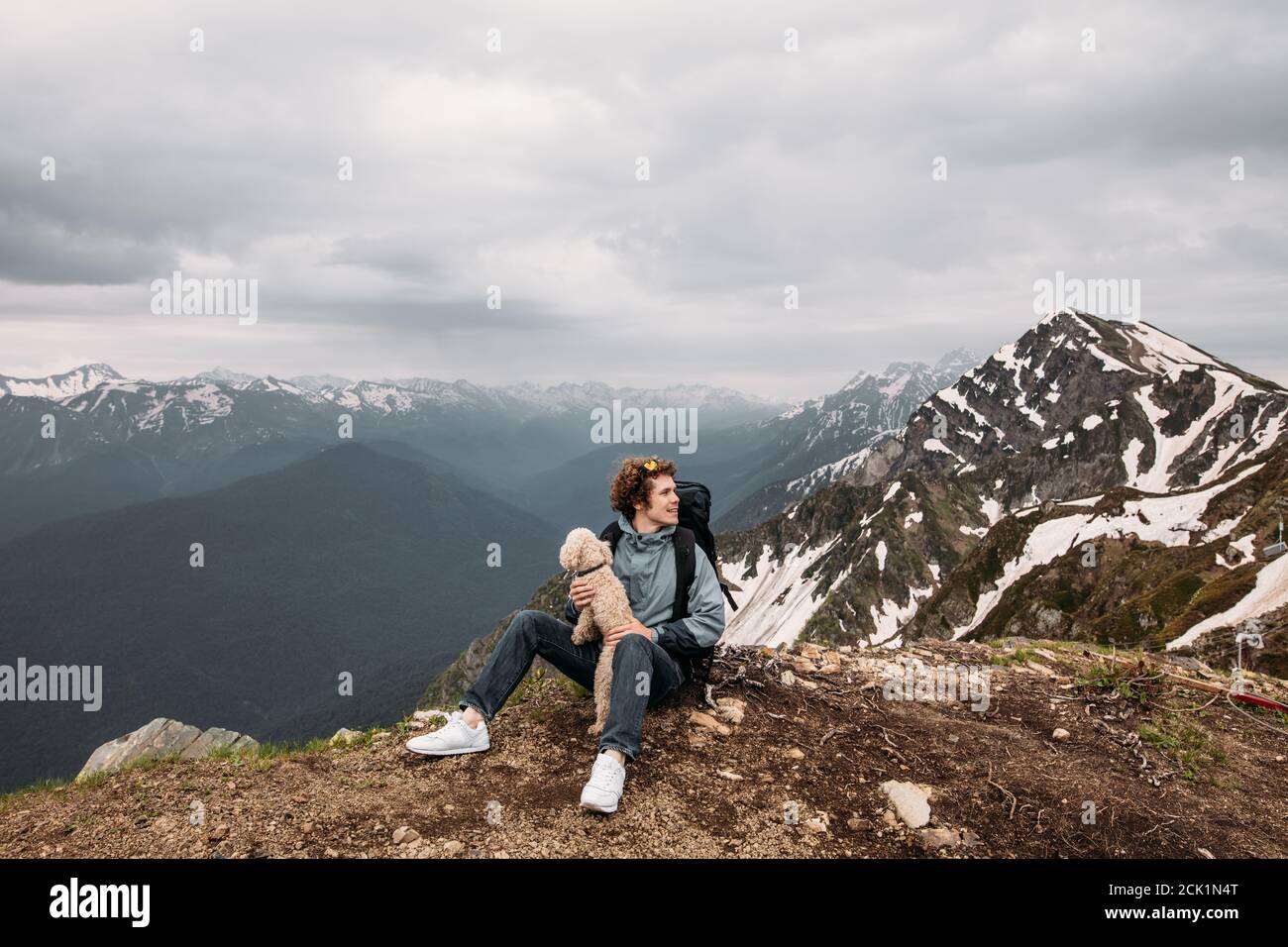 adventurous male with his pet on amazing landscape, full length photo ...