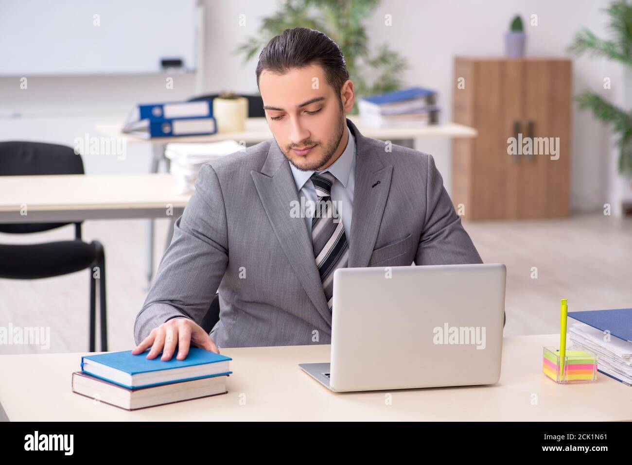 Male employee working in the office Stock Photo - Alamy