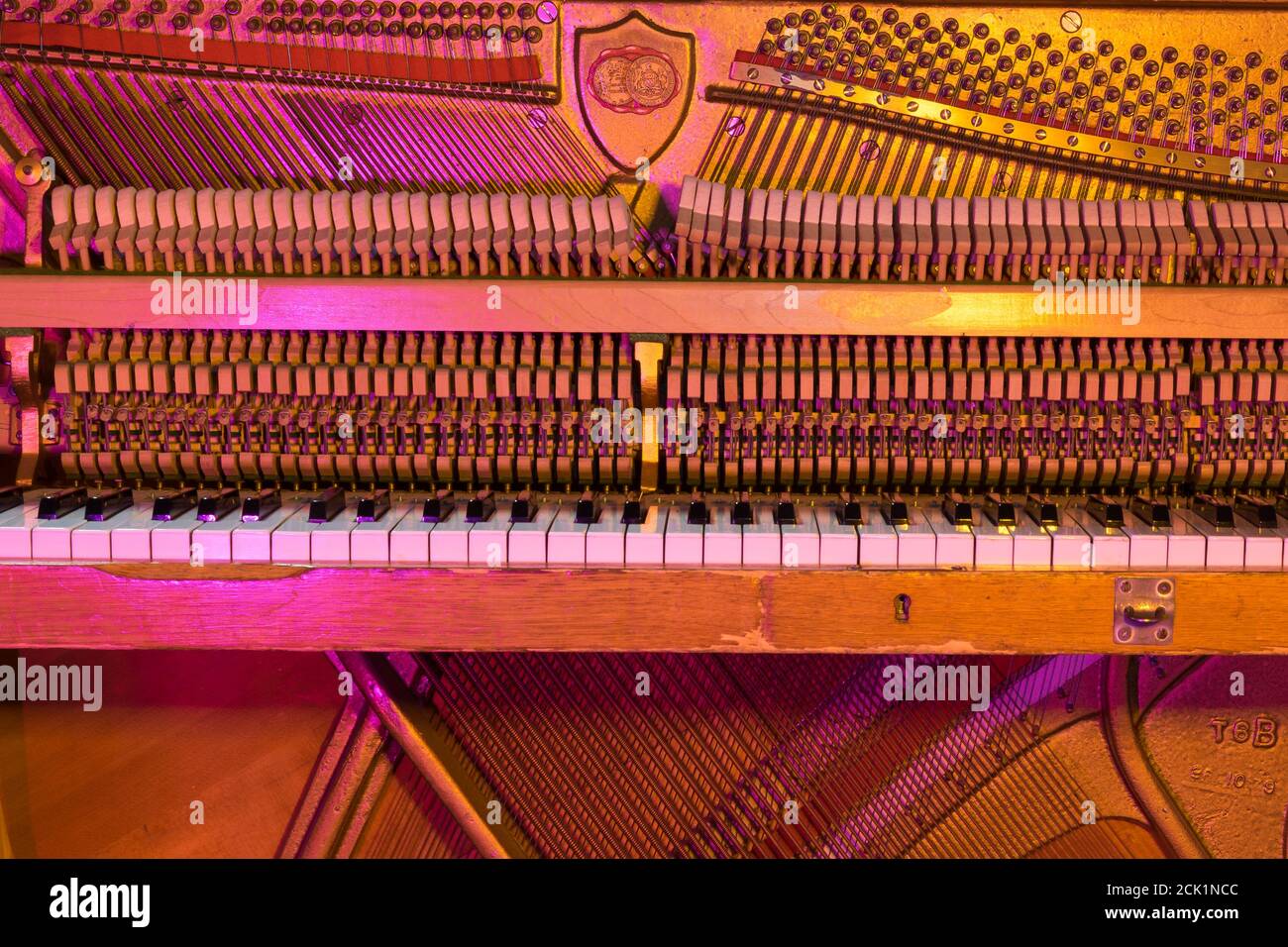 The inside workings of an upright piano showing the strings and hammers ...