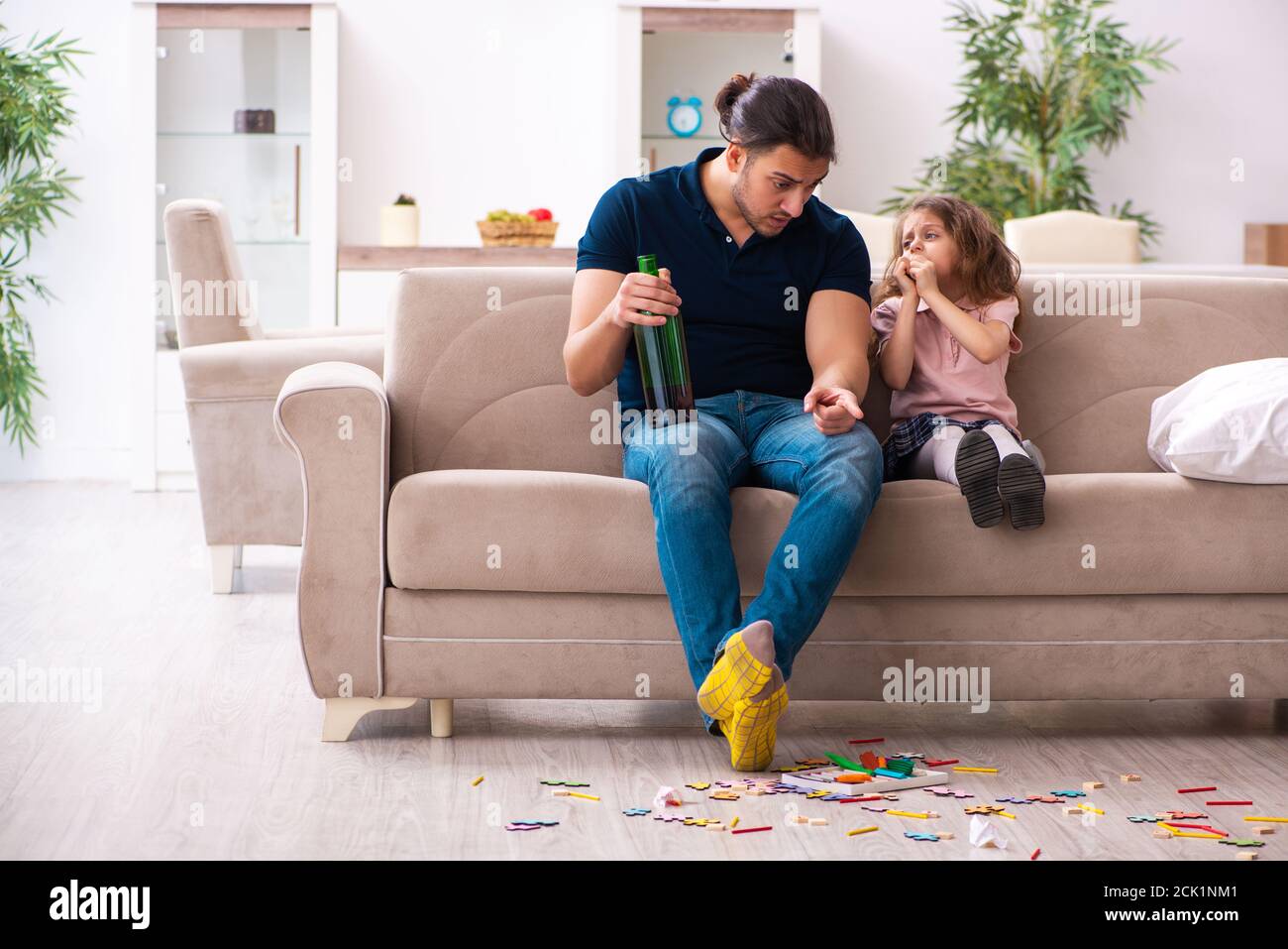 Drunk father and little girl at home Stock Photo - Alamy