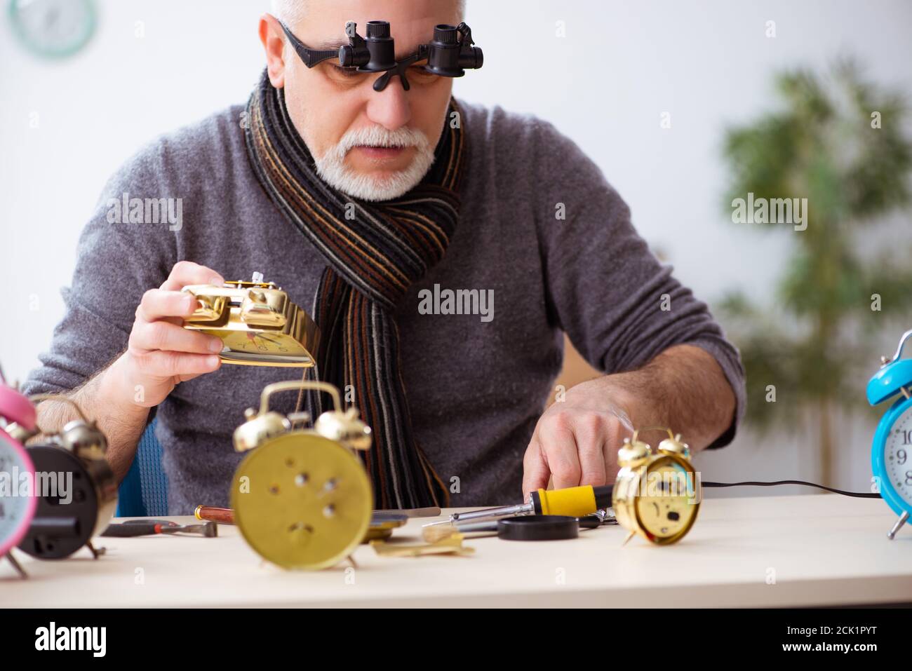 Old watchmaker working in the workshop Stock Photo - Alamy