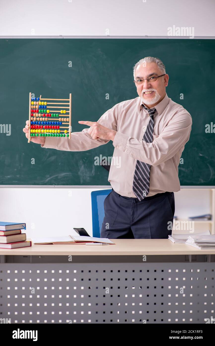 Old experienced teacher in the classroom Stock Photo - Alamy