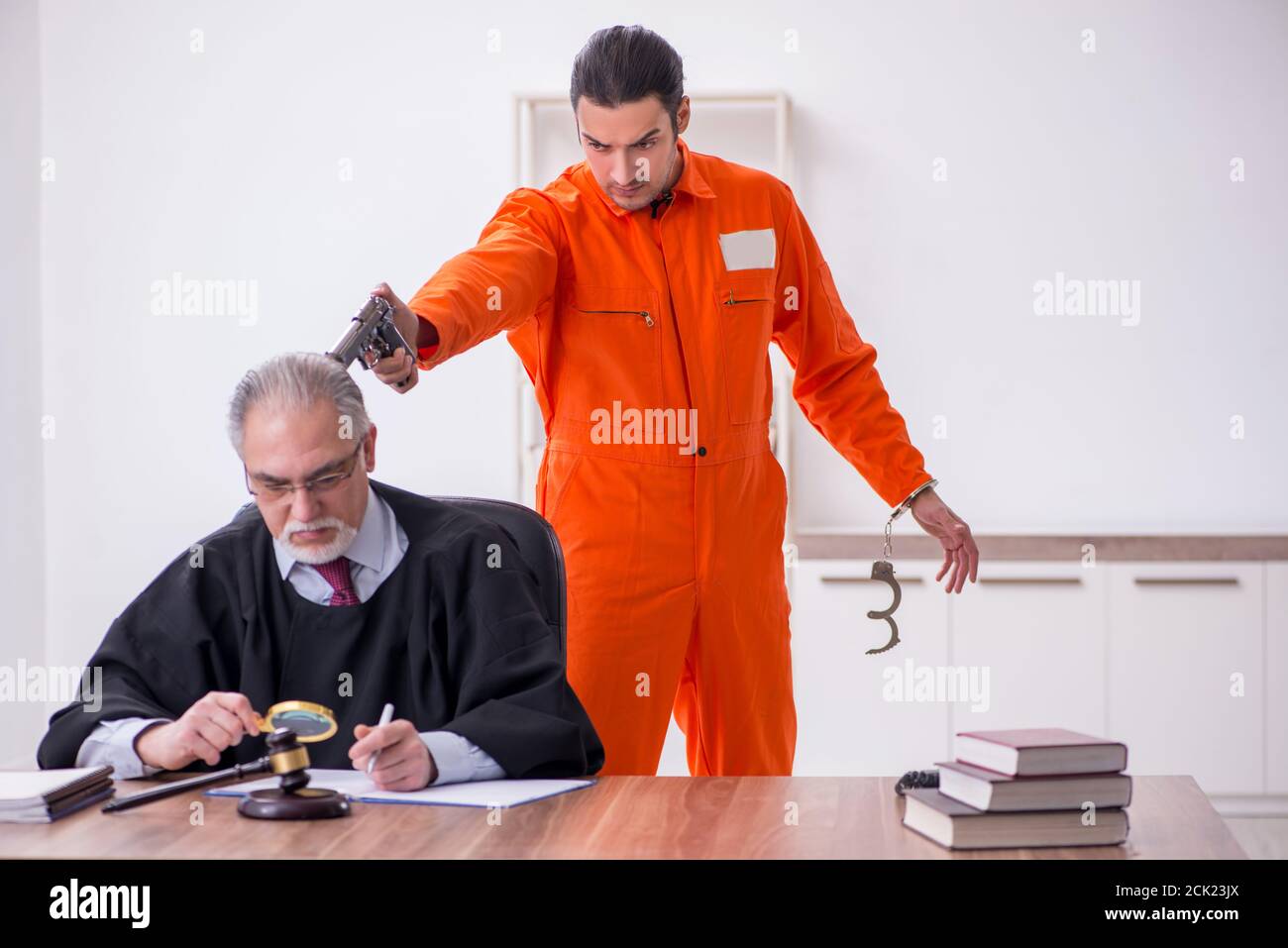 Old judge meeting with young captive in courthouse Stock Photo - Alamy