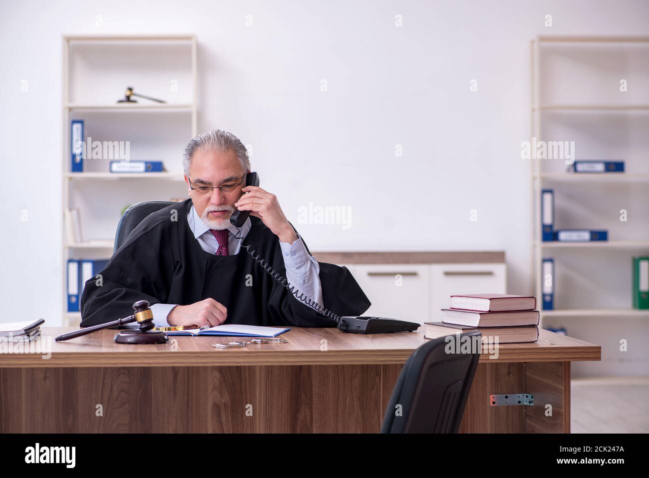 Old judge working in the courthouse Stock Photo - Alamy
