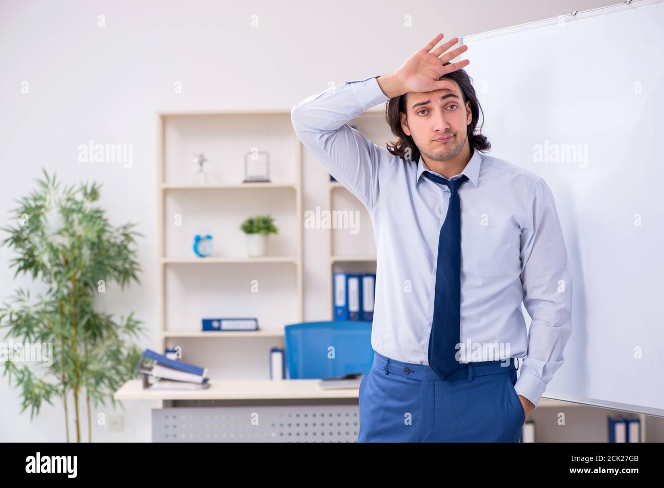 Young man employee presenting in the office Stock Photo - Alamy