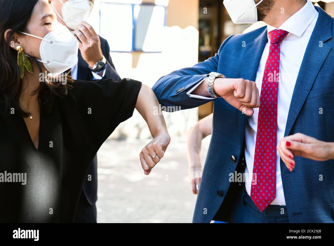 Two people touch their elbows in greeting, wearing a mask Stock Photo ...