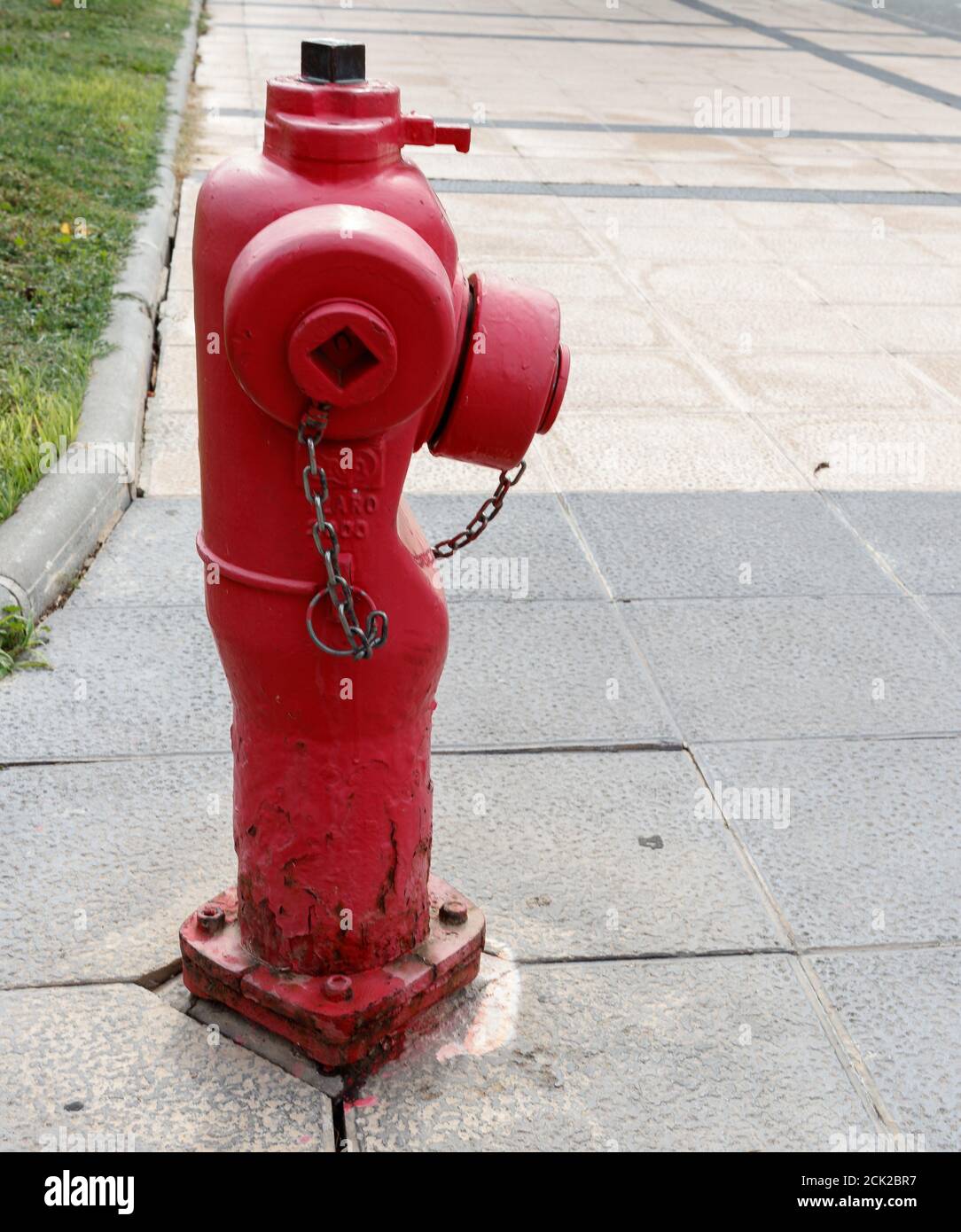 Vertical shot of a fire hydrant on a sidewalk Stock Photo - Alamy