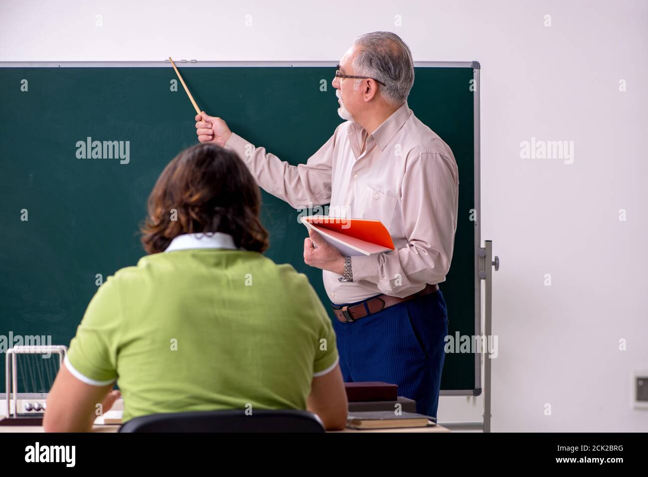 Old professor physicist and student in the classroom Stock Photo - Alamy