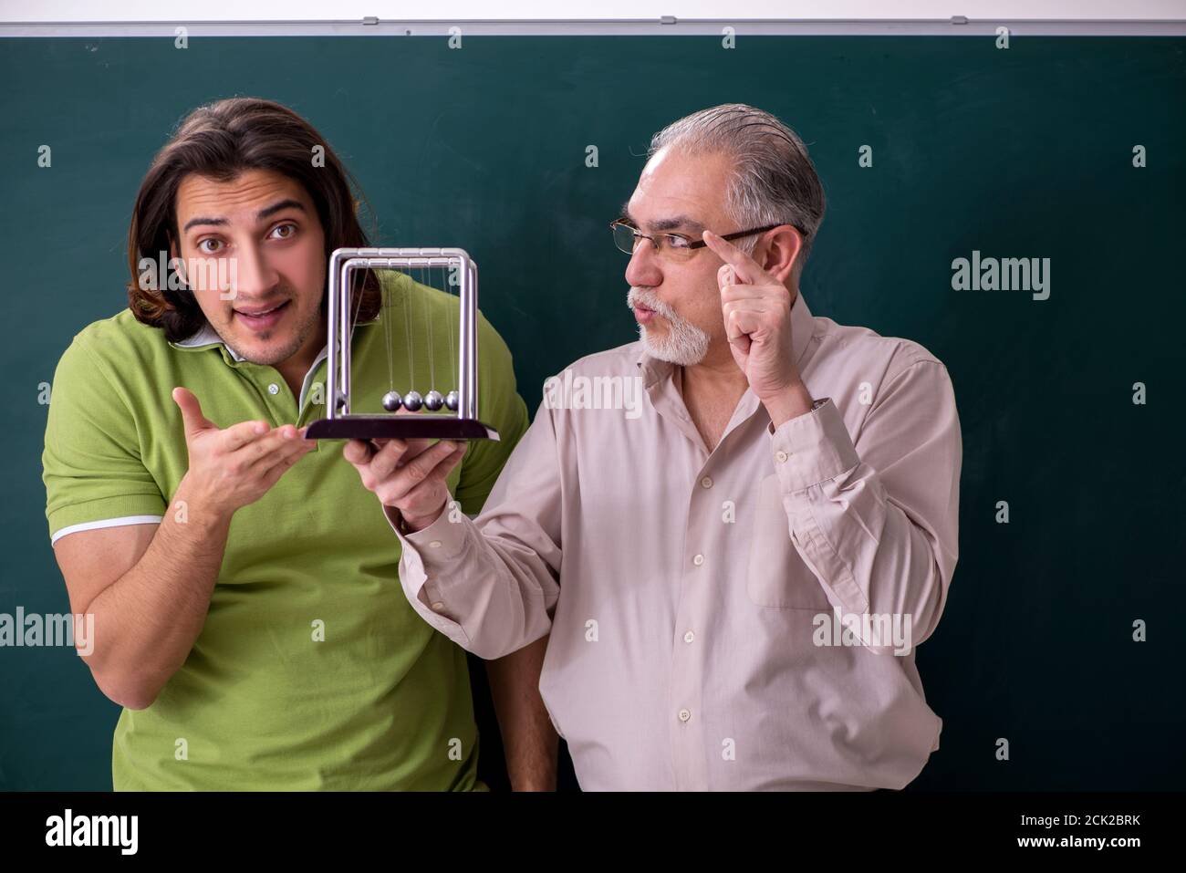Old professor physicist and student in the classroom Stock Photo - Alamy
