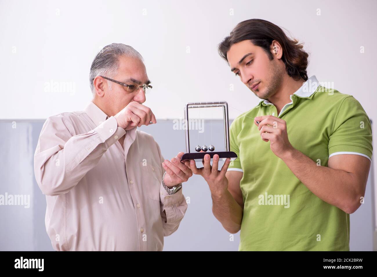 Old professor physicist and student in the classroom Stock Photo - Alamy