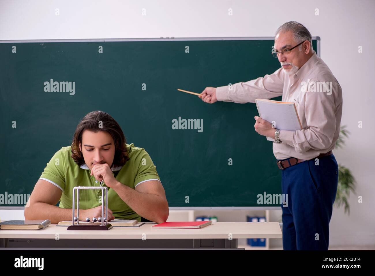 Old professor physicist and student in the classroom Stock Photo - Alamy