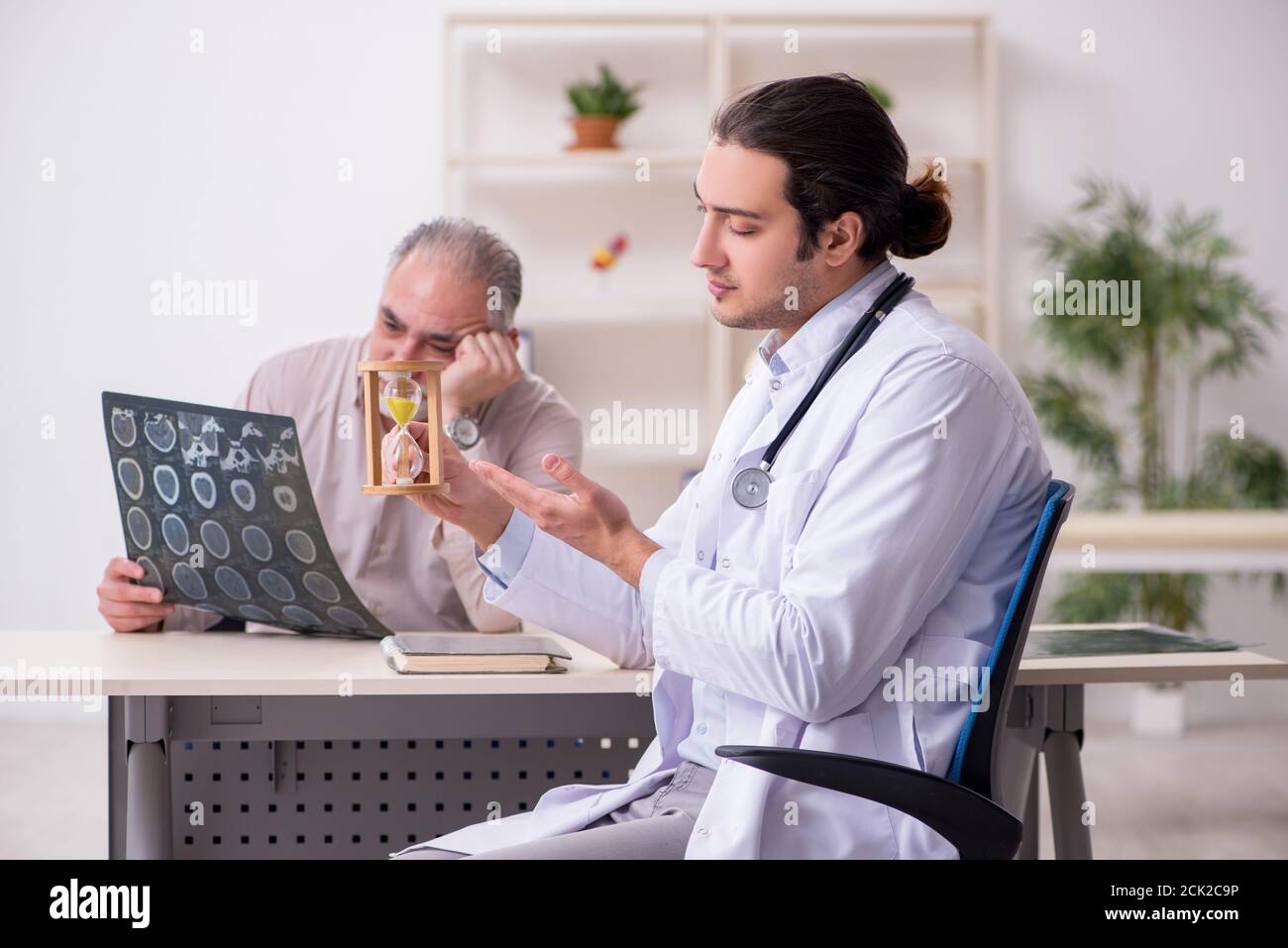 Male patient visiting doctor radiologist in time management concept ...