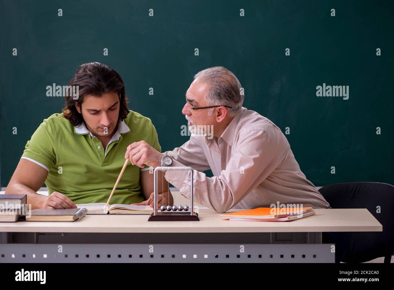 Old professor physicist and student in the classroom Stock Photo - Alamy