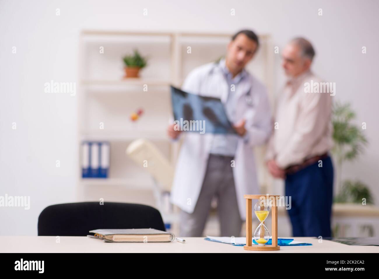 Male patient visiting doctor radiologist in time management concept ...