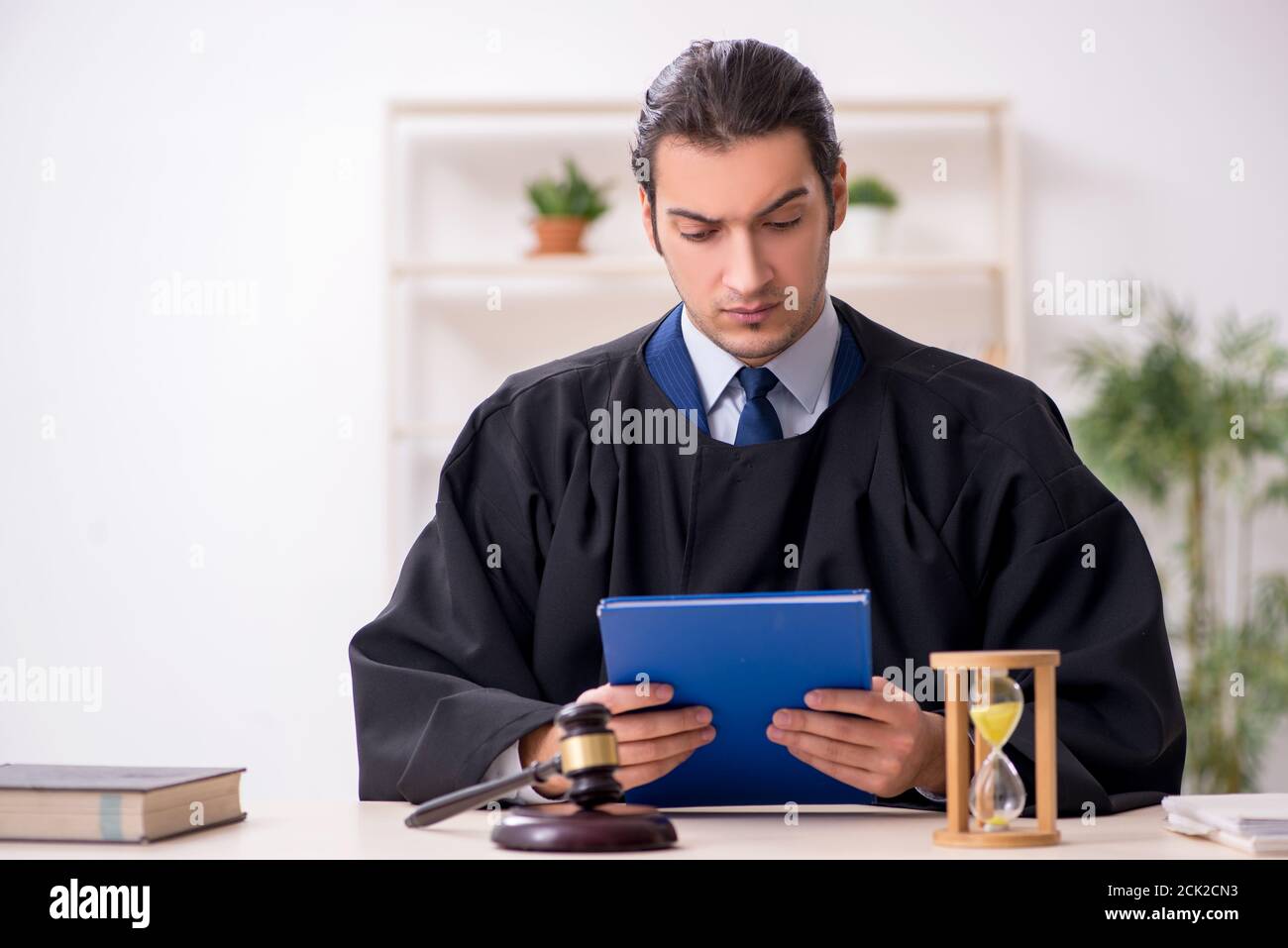 Young judge in time management concept Stock Photo - Alamy