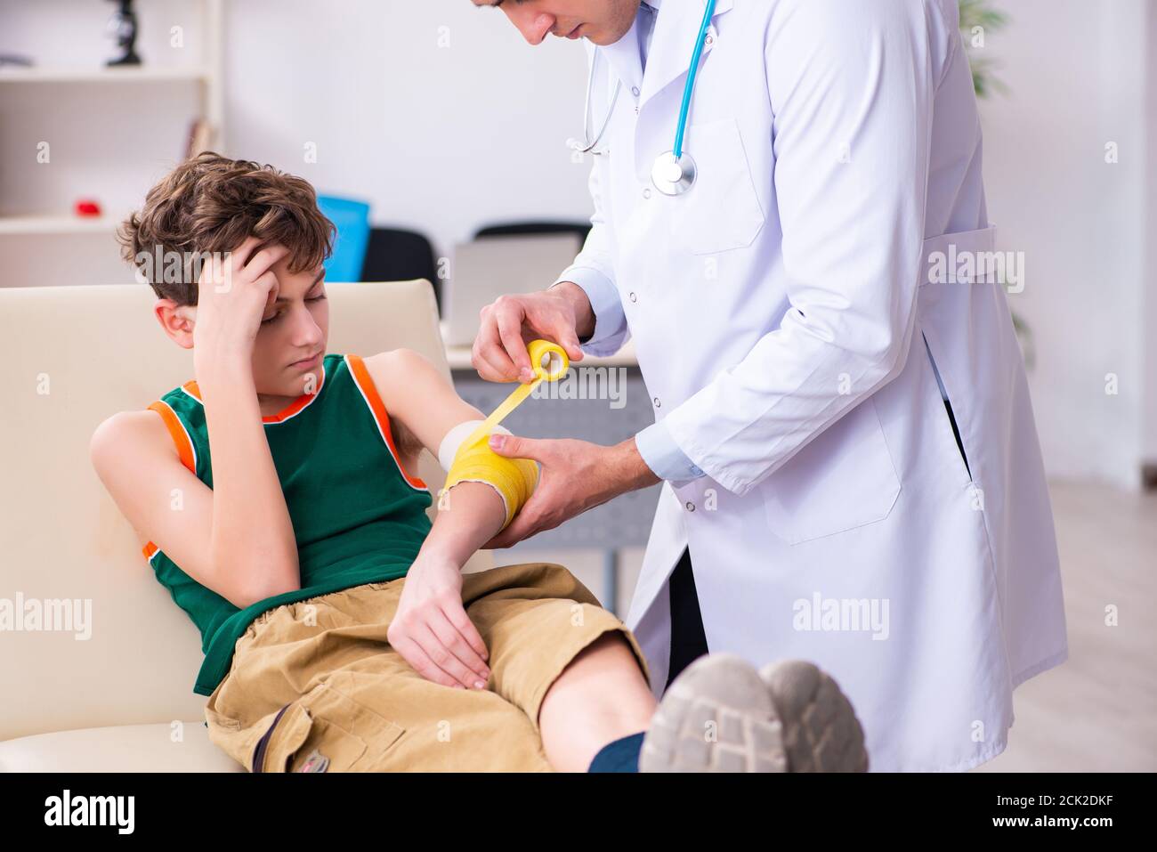 Sick boy visiting young doctor pediatrician Stock Photo - Alamy