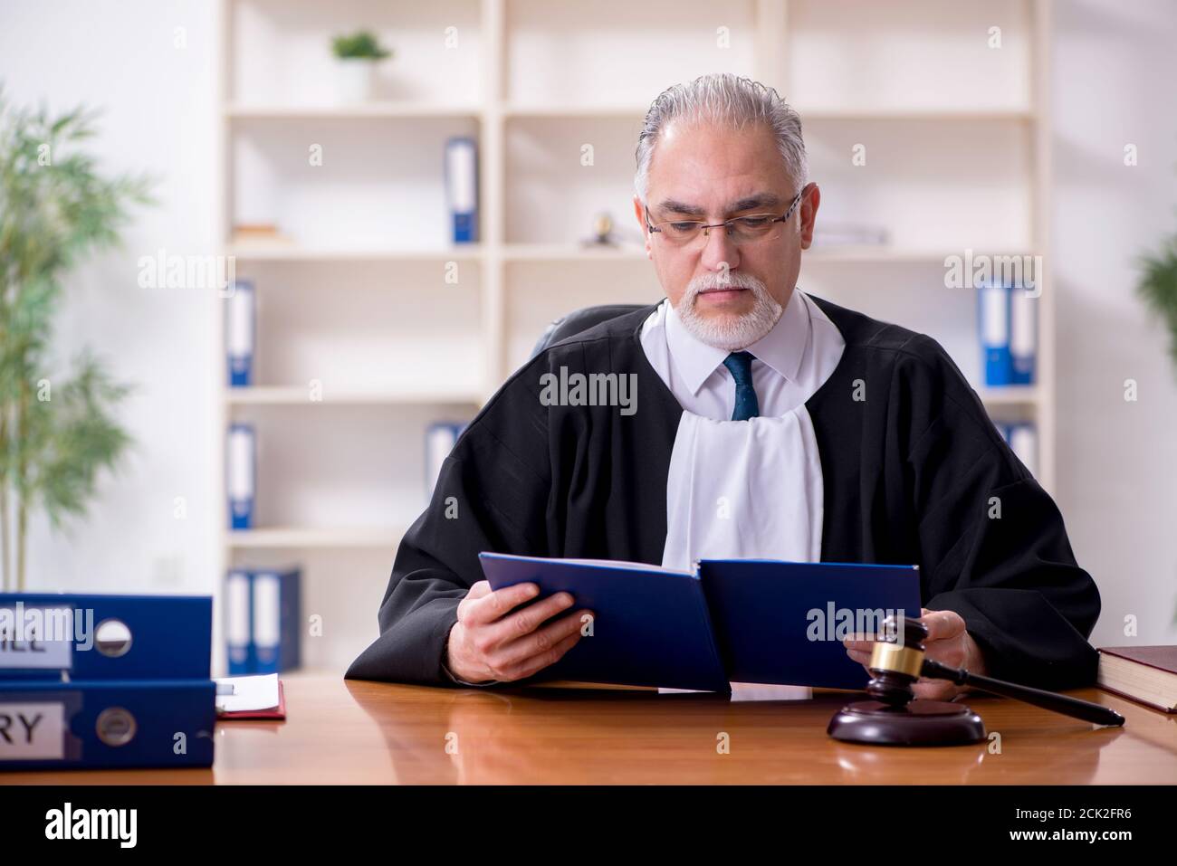 Old judge working in courthouse Stock Photo - Alamy