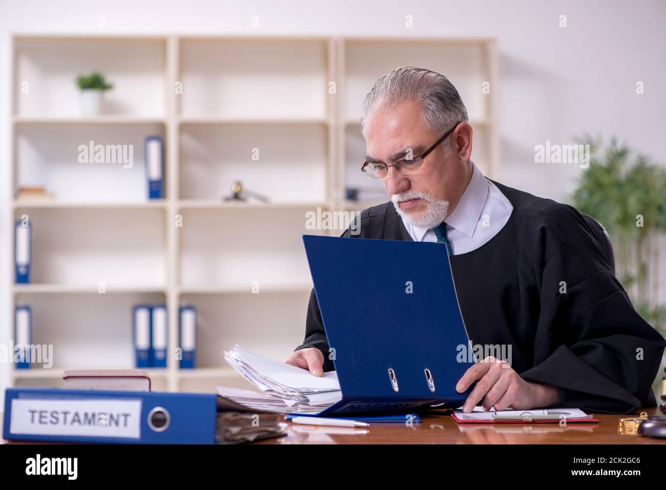 Old male judge working in the courthouse Stock Photo - Alamy