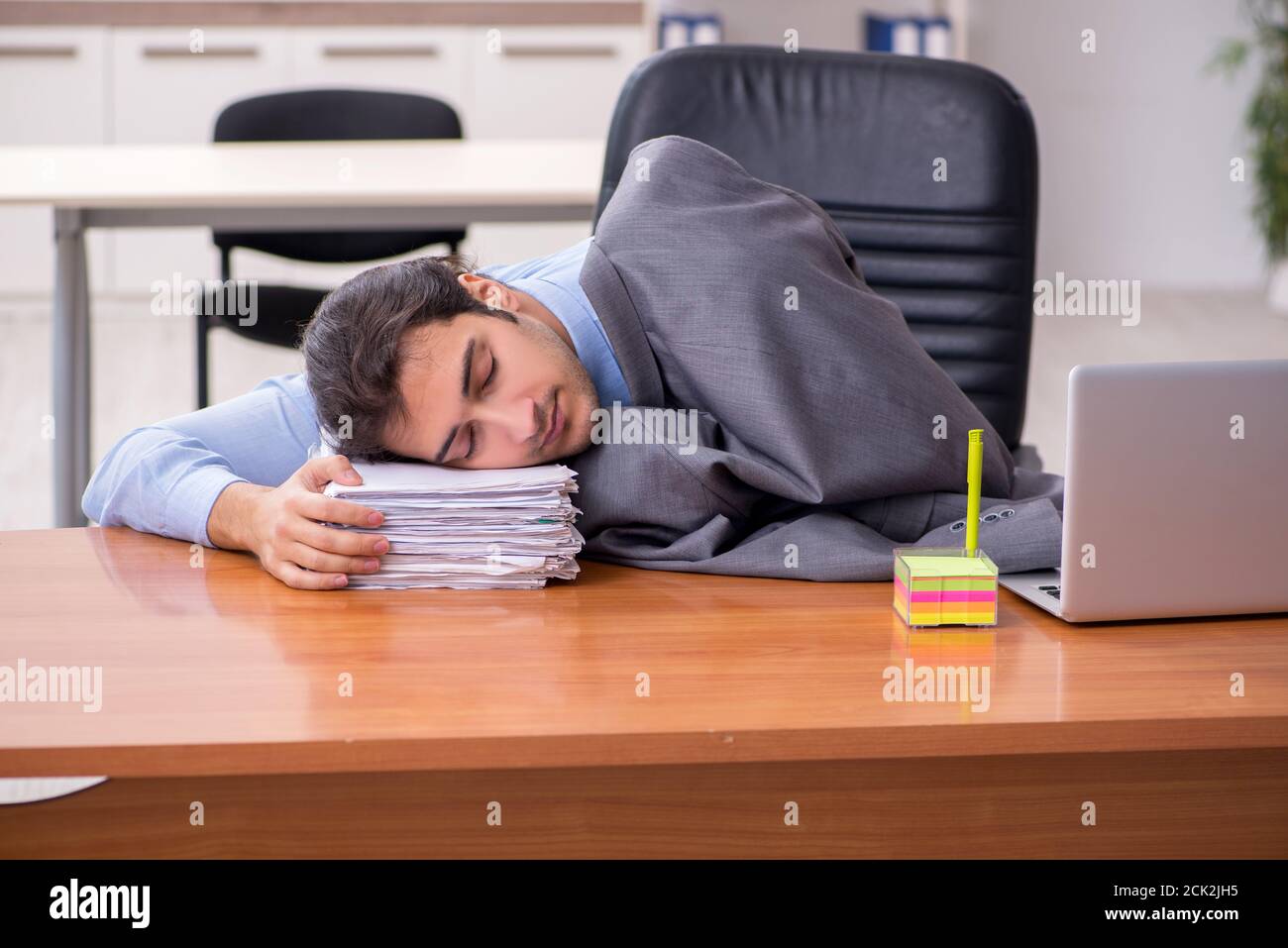 Young employee sleeping in the office Stock Photo - Alamy