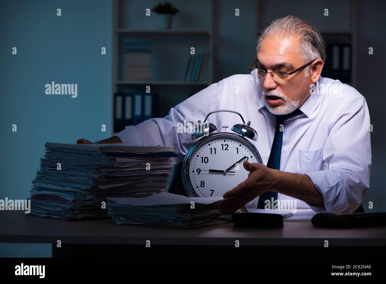 Old employee working late in the office Stock Photo - Alamy