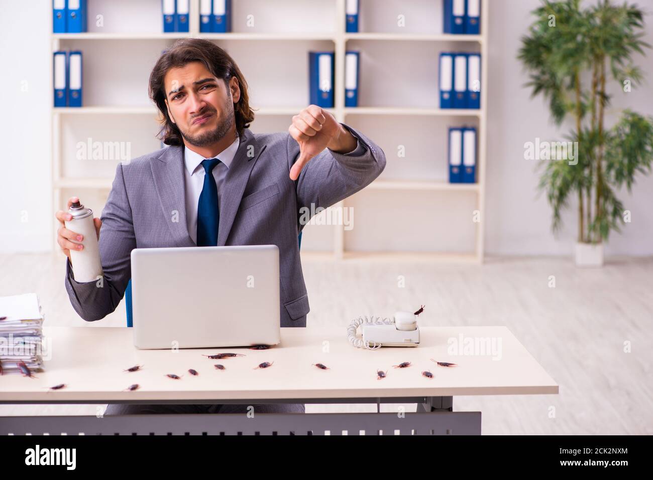 Young employee and too many cockroaches in the office Stock Photo - Alamy