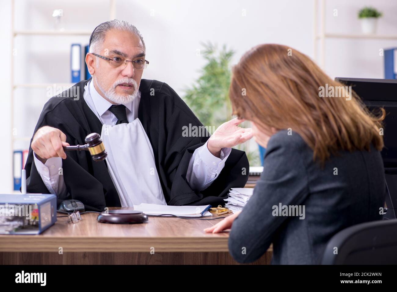 Old judge and female client in the office Stock Photo - Alamy