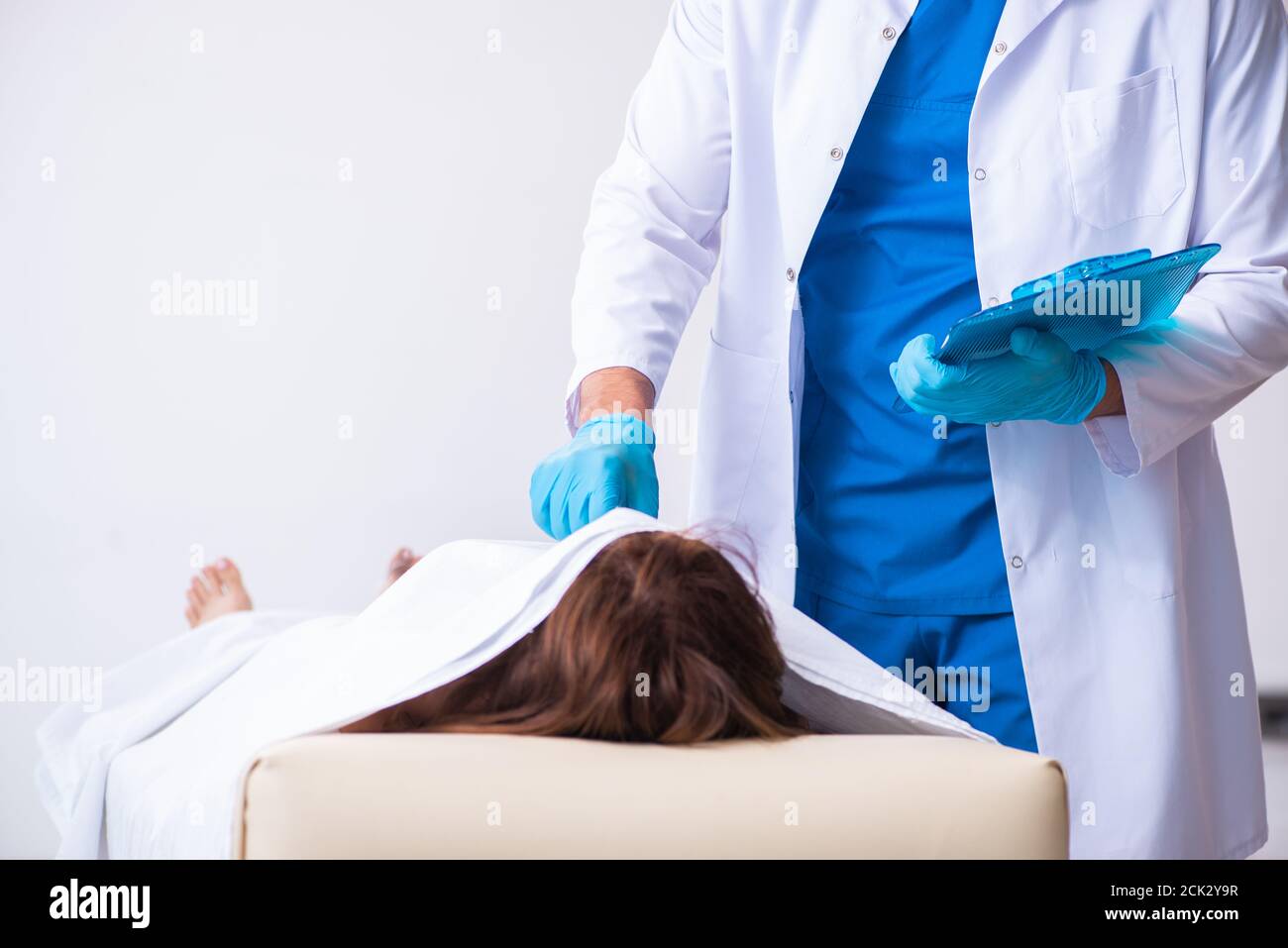 Police coroner examining dead body in morgue Stock Photo - Alamy