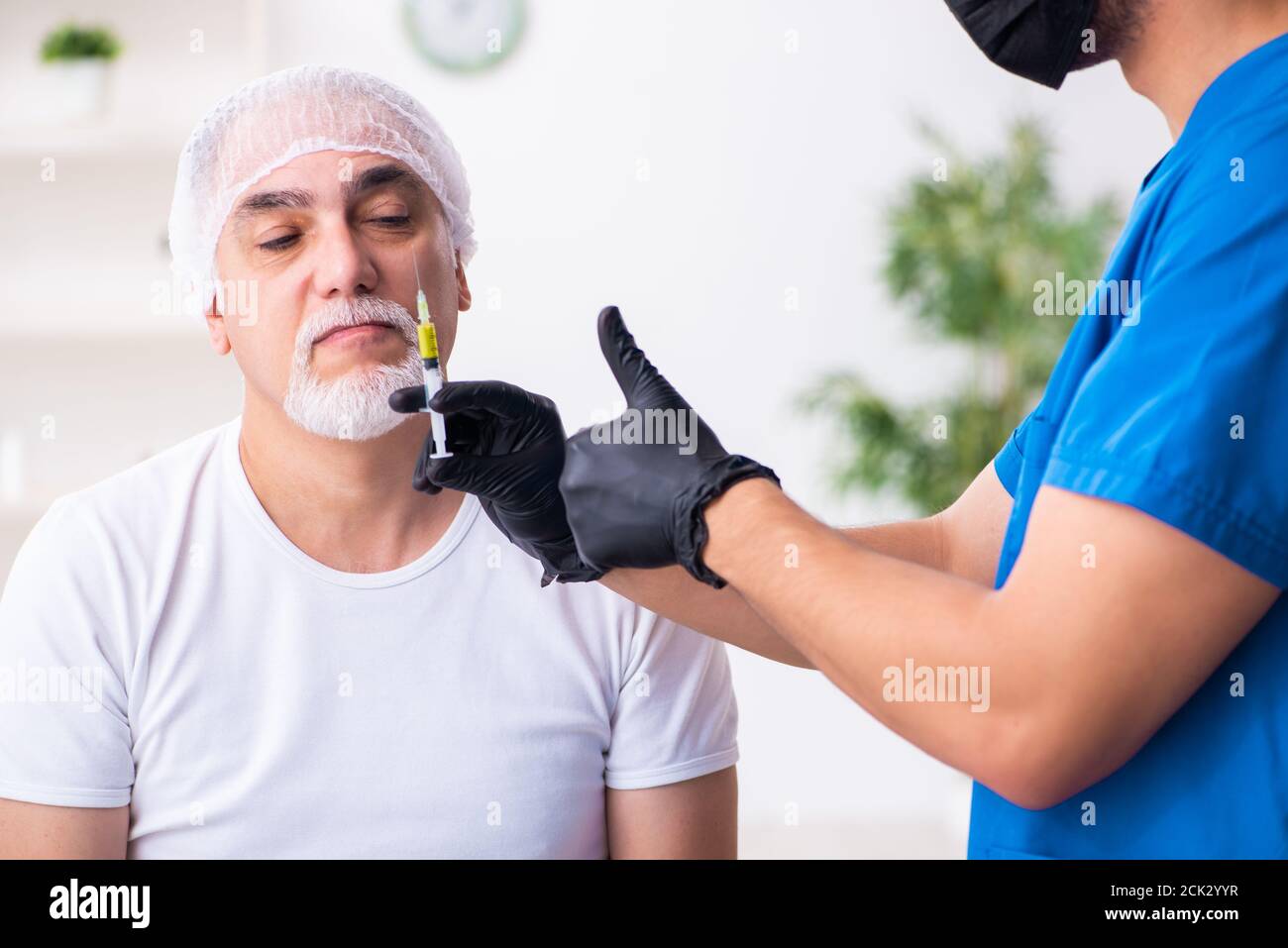 Doctor giving face lifting injection hi-res stock photography and ...