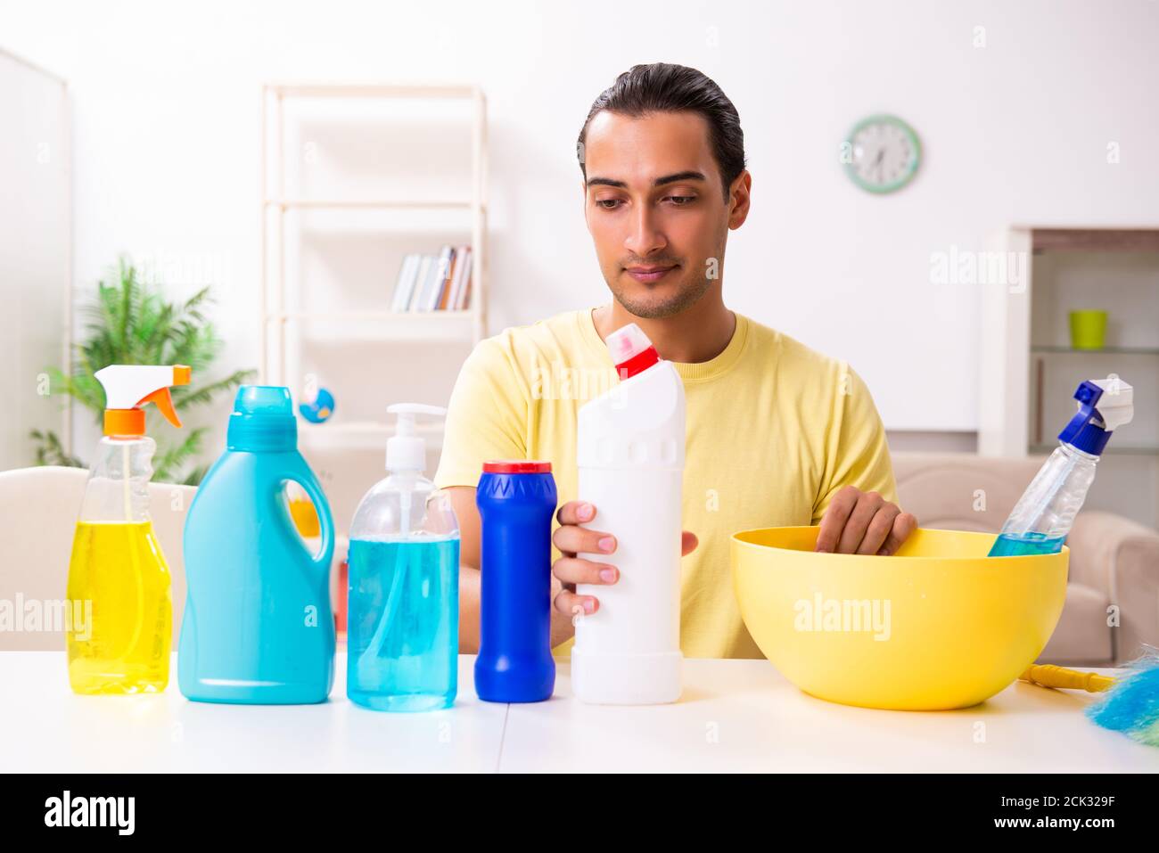 Young contractor doing housework at home Stock Photo - Alamy