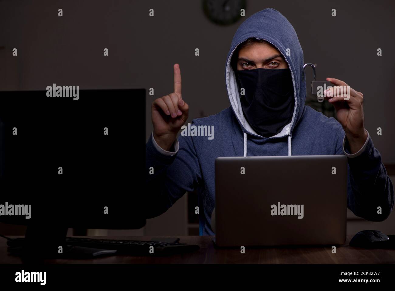 Male hacker hacking security firewall late in the office Stock Photo ...