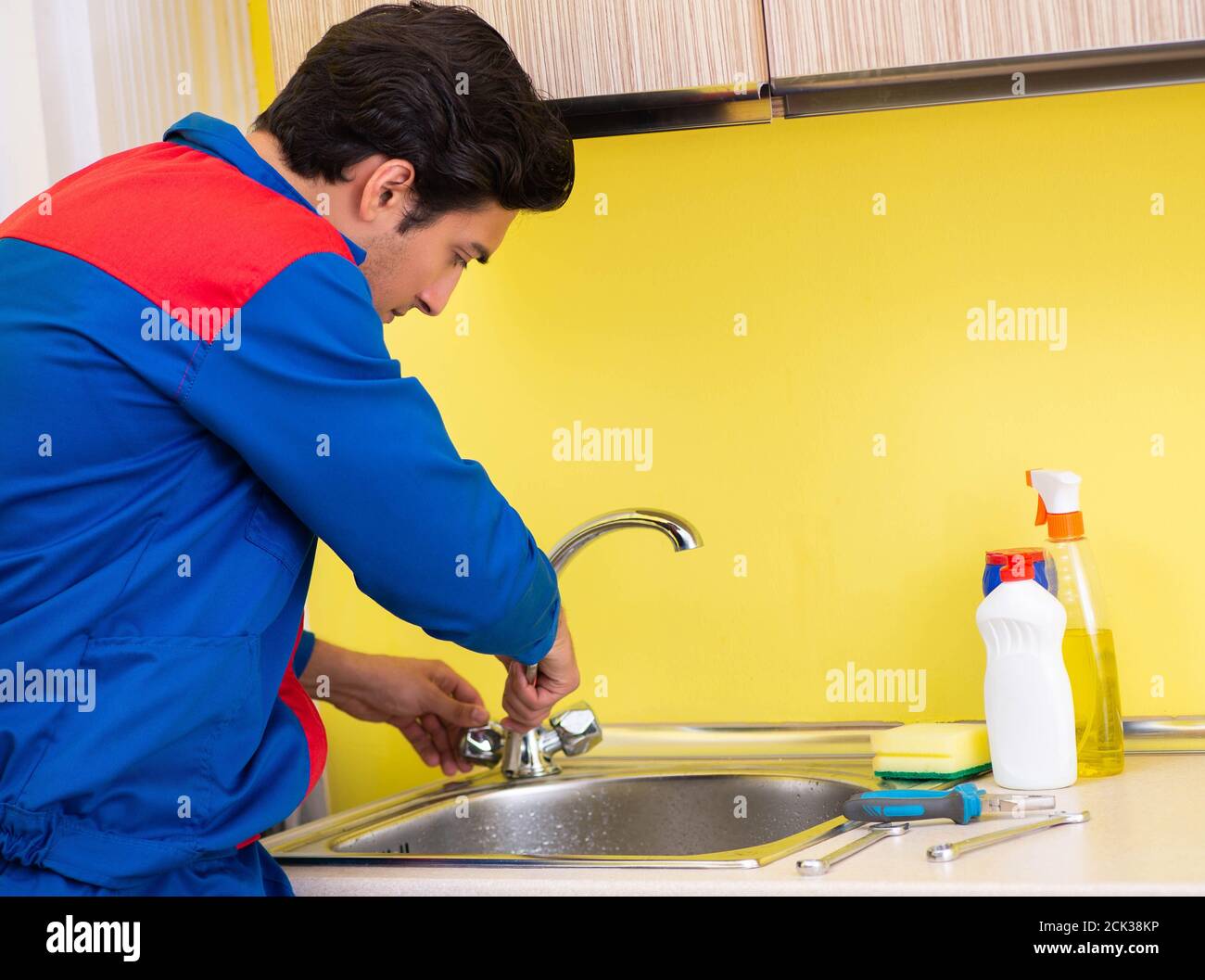 The plumber repairing tap at kitchen Stock Photo - Alamy