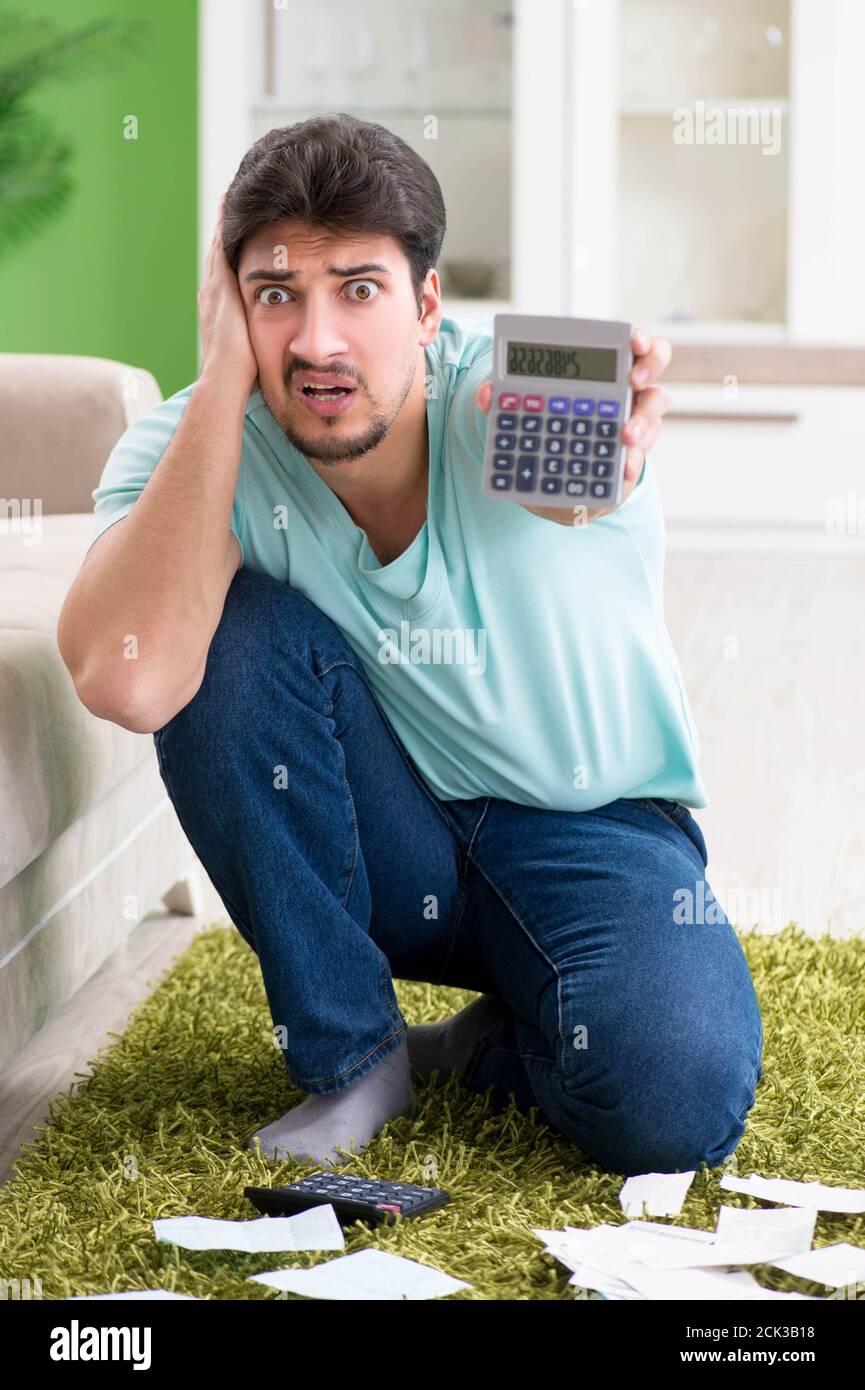 The young man struggling with personal finance and bills Stock Photo ...