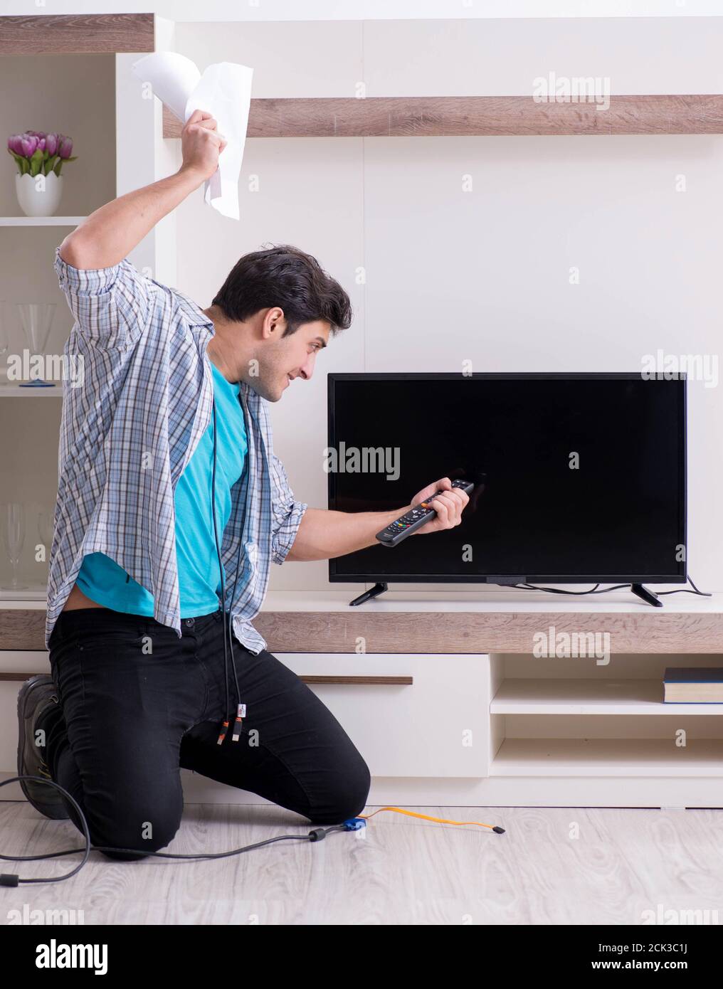 The man trying to fix broken tv Stock Photo - Alamy