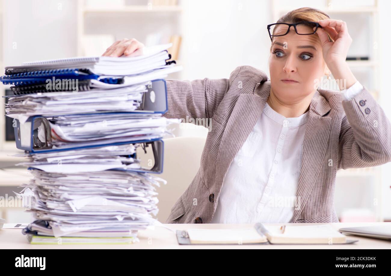 The businesswoman very busy with ongoing paperwork Stock Photo - Alamy
