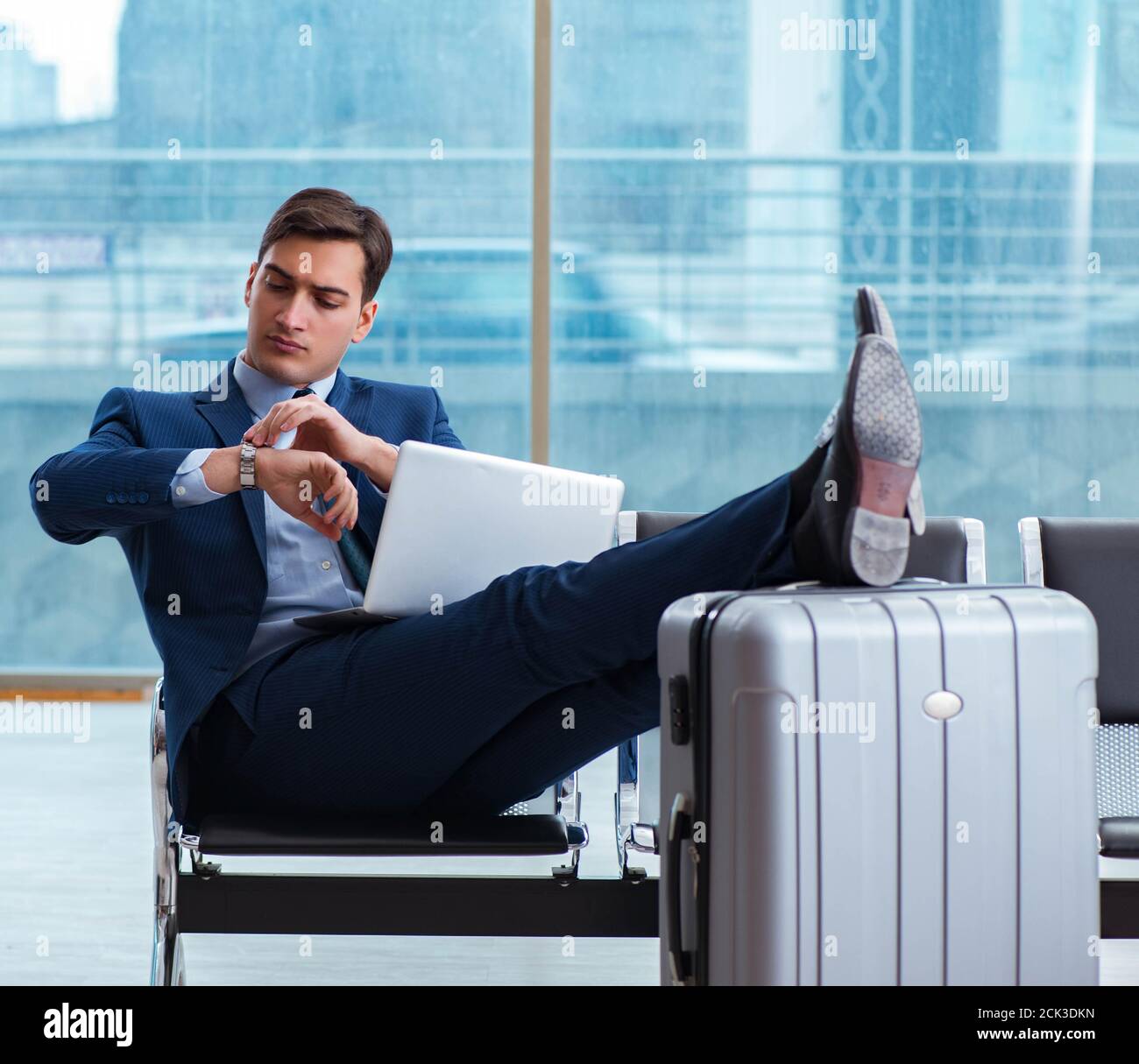 Businessman waiting at the airport for his plane in business class Stock Photo - Alamy