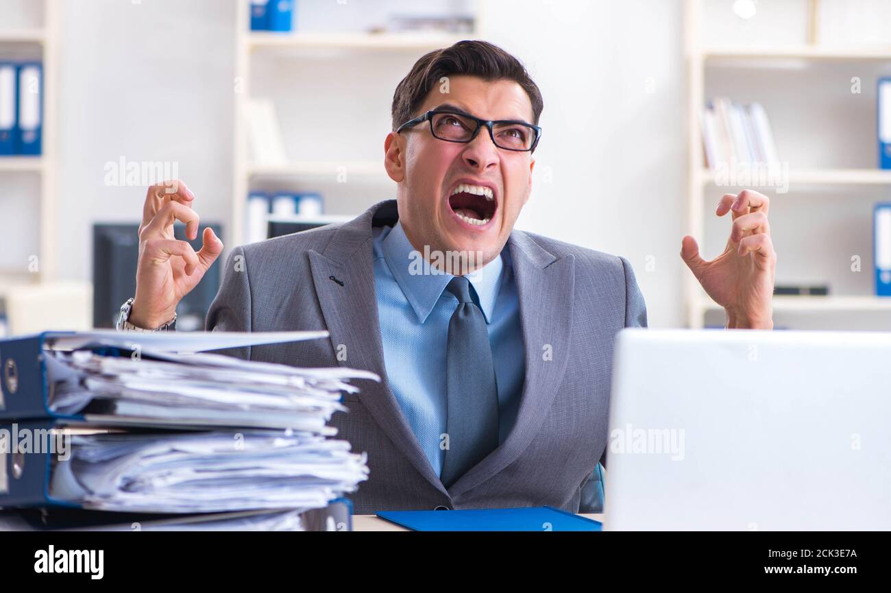The overloaded with work employee under paperwork burden Stock Photo ...