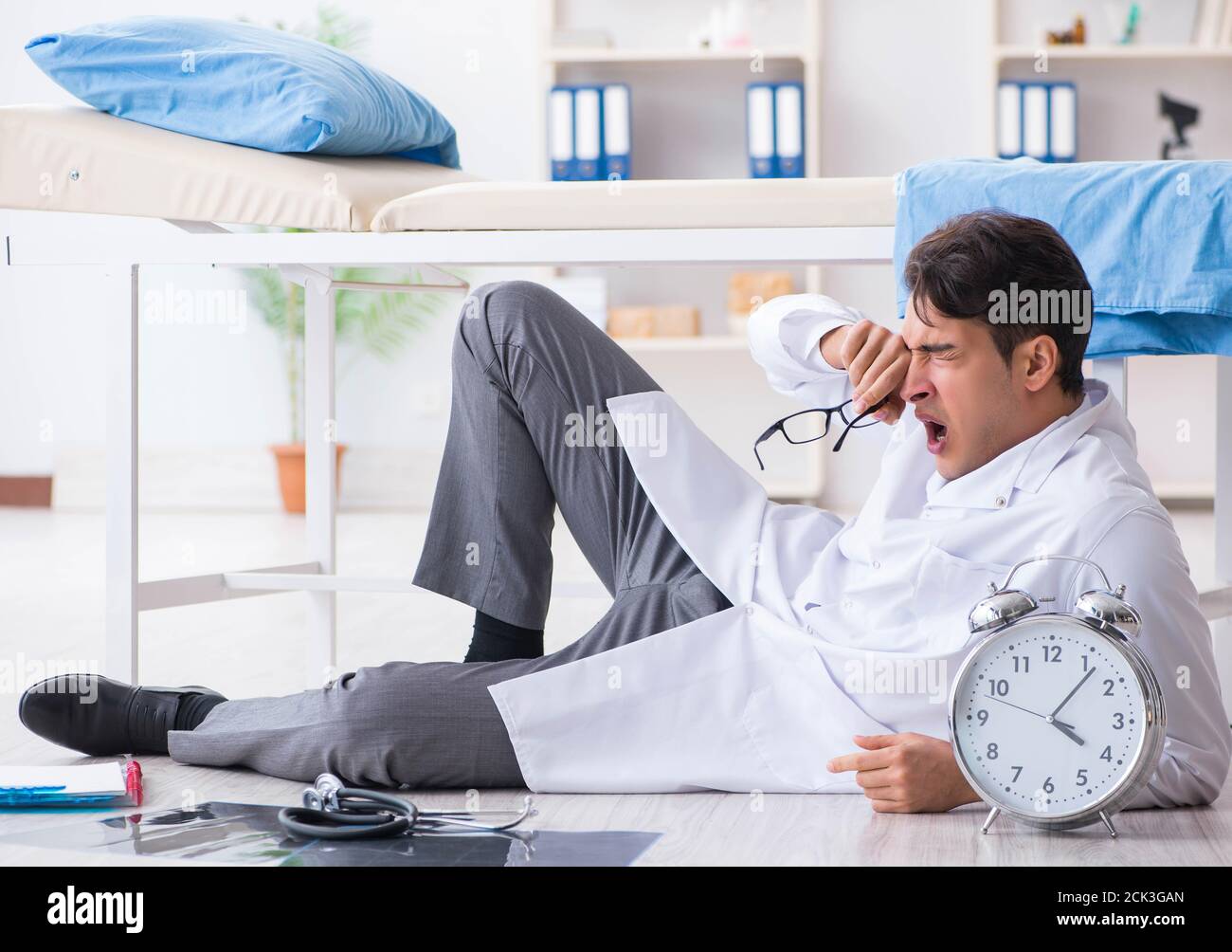 The sleepy doctor tired after long night shift Stock Photo - Alamy