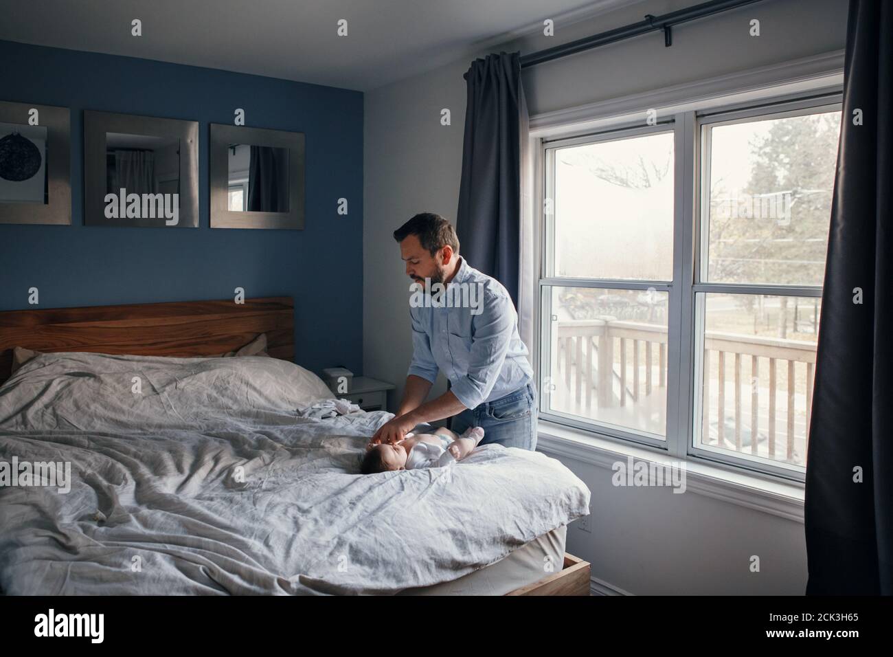 Middle age Caucasian father changing diaper clothes for newborn baby ...