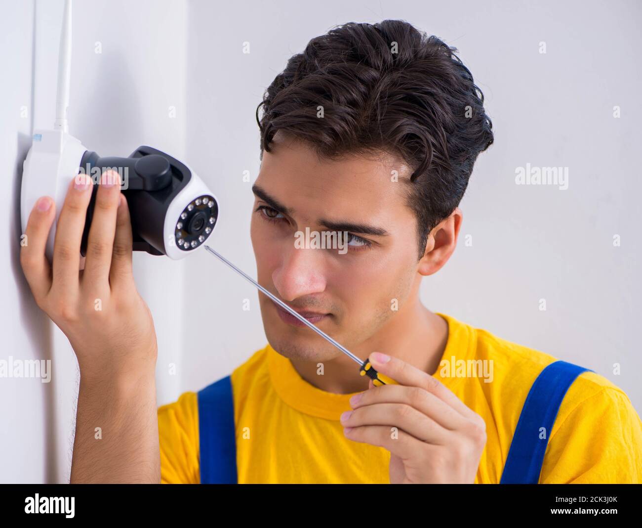 The contractor installing surveillance cctv cameras in office Stock ...