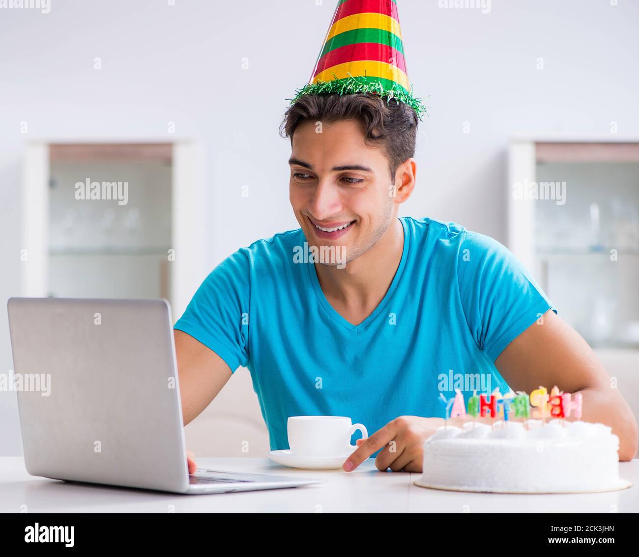 The young man celebrating birthday alone at home Stock Photo - Alamy