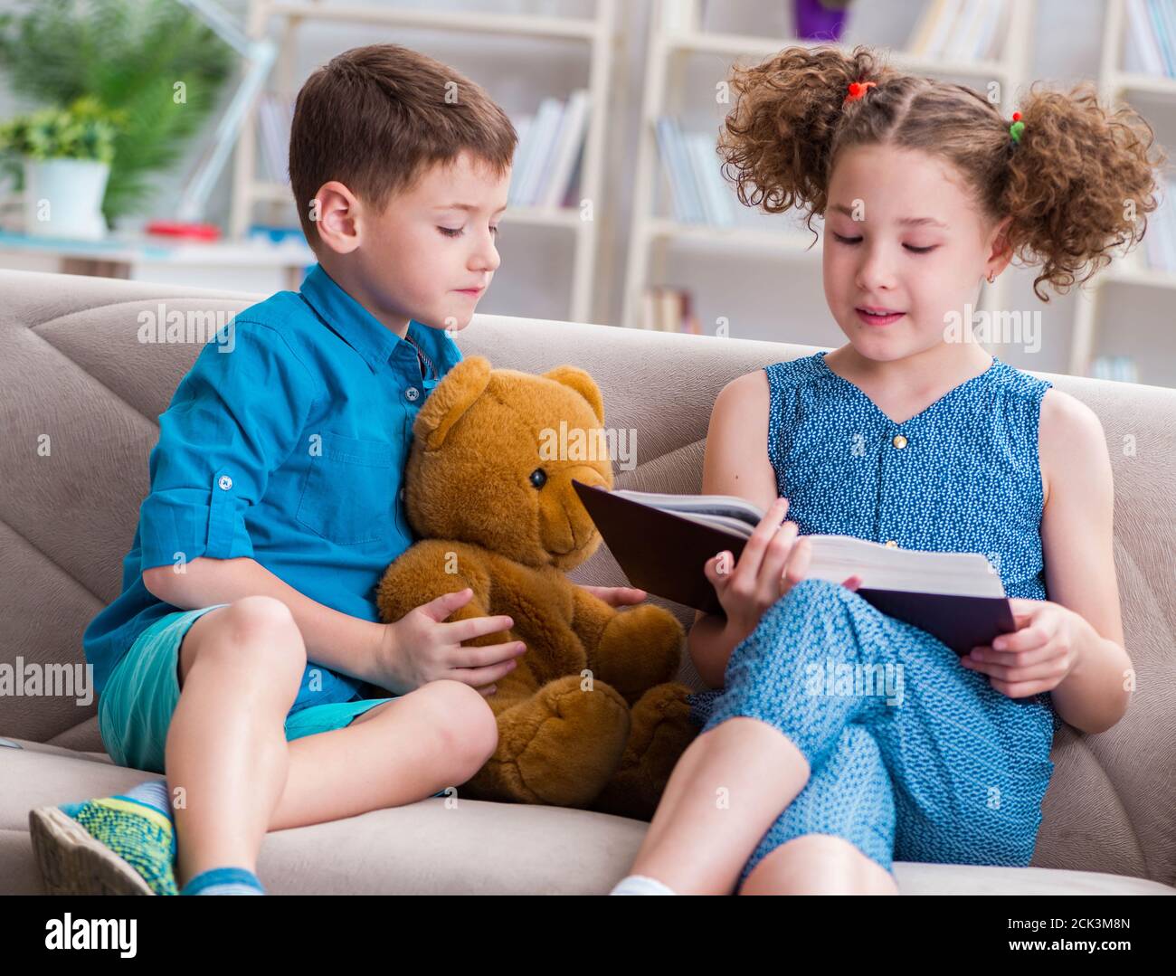 The two kids reading books at home Stock Photo - Alamy